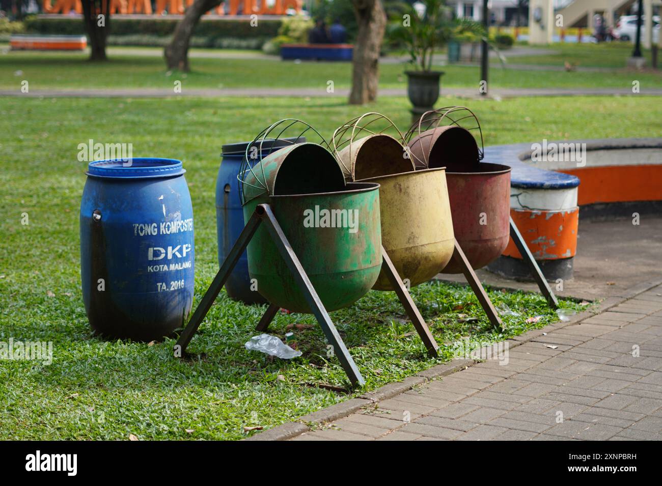Trash cans with unique shapes that look old and dirty in the open ...