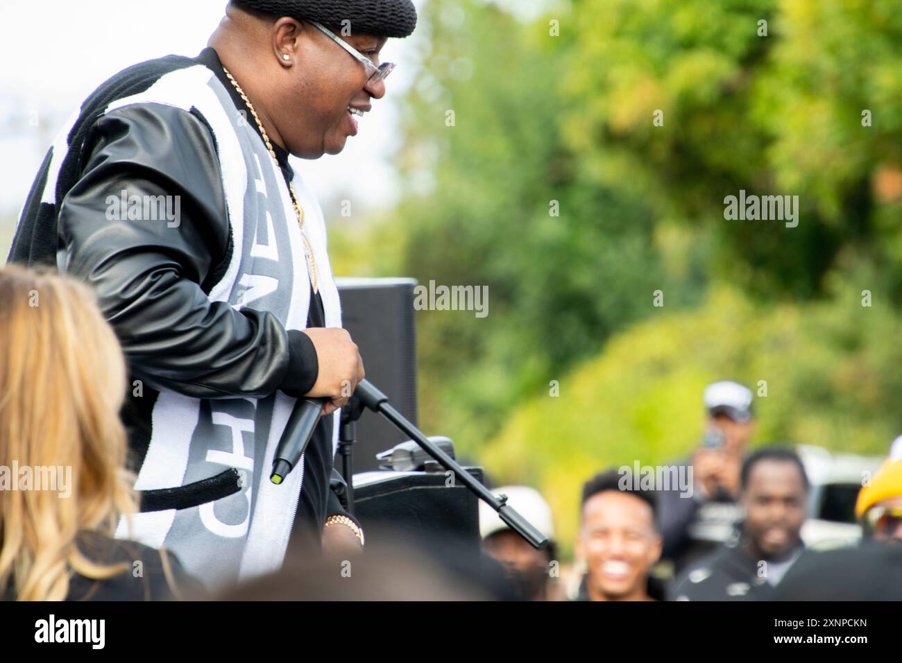 Rapper E-40 addresses fans during a ceremony to give him the key to the ...