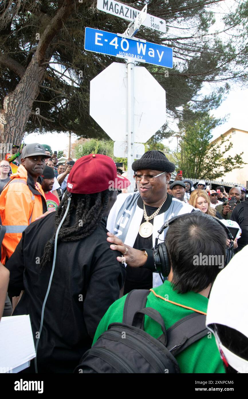 E-40 greets a friend at a sign designating his childhood street in ...