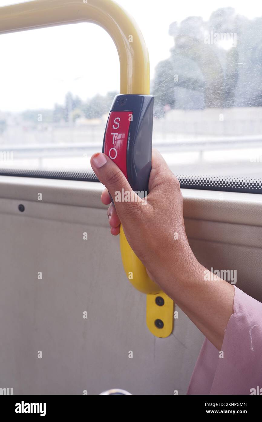 hand pressing the Bus bell switch for stop inside the public bus Stock ...