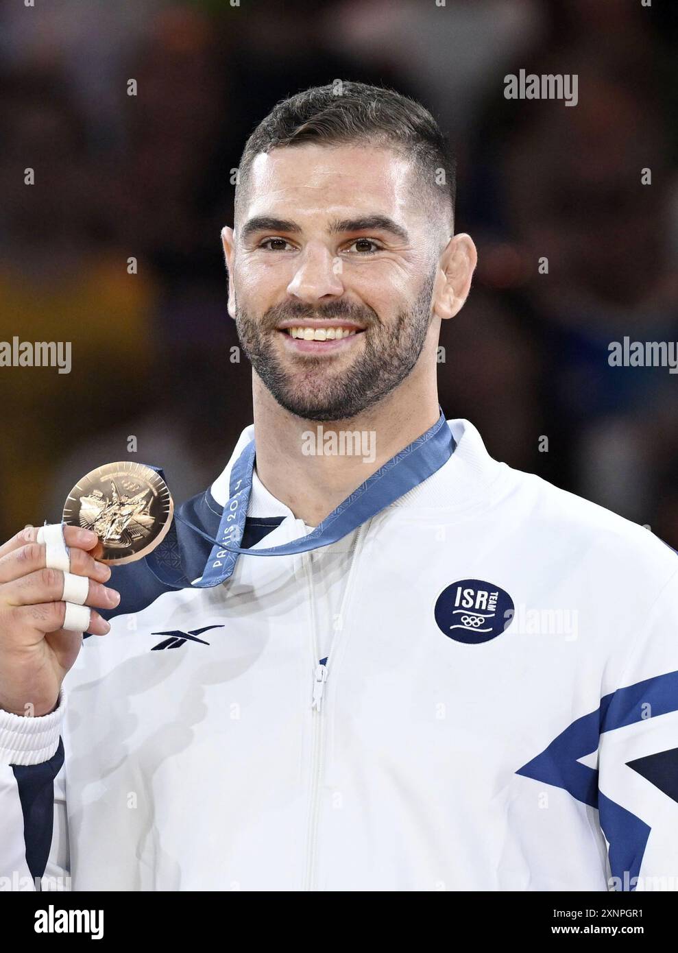 Peter Paltchik of Israel poses with his bronze medal in the men's judo ...