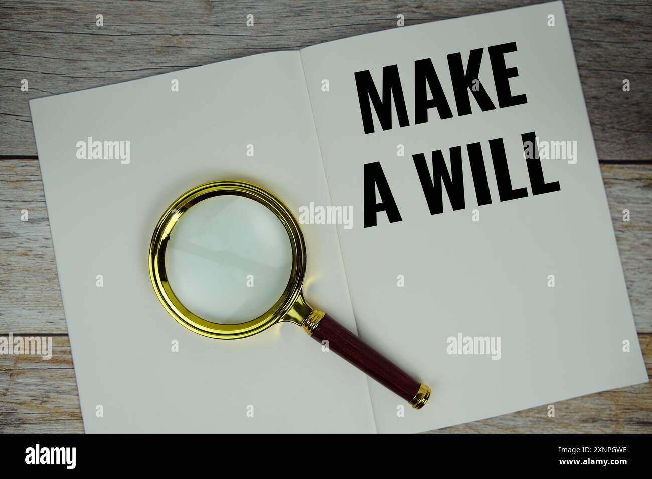 Make a will text on note page with magnifying glass top view on wooden ...