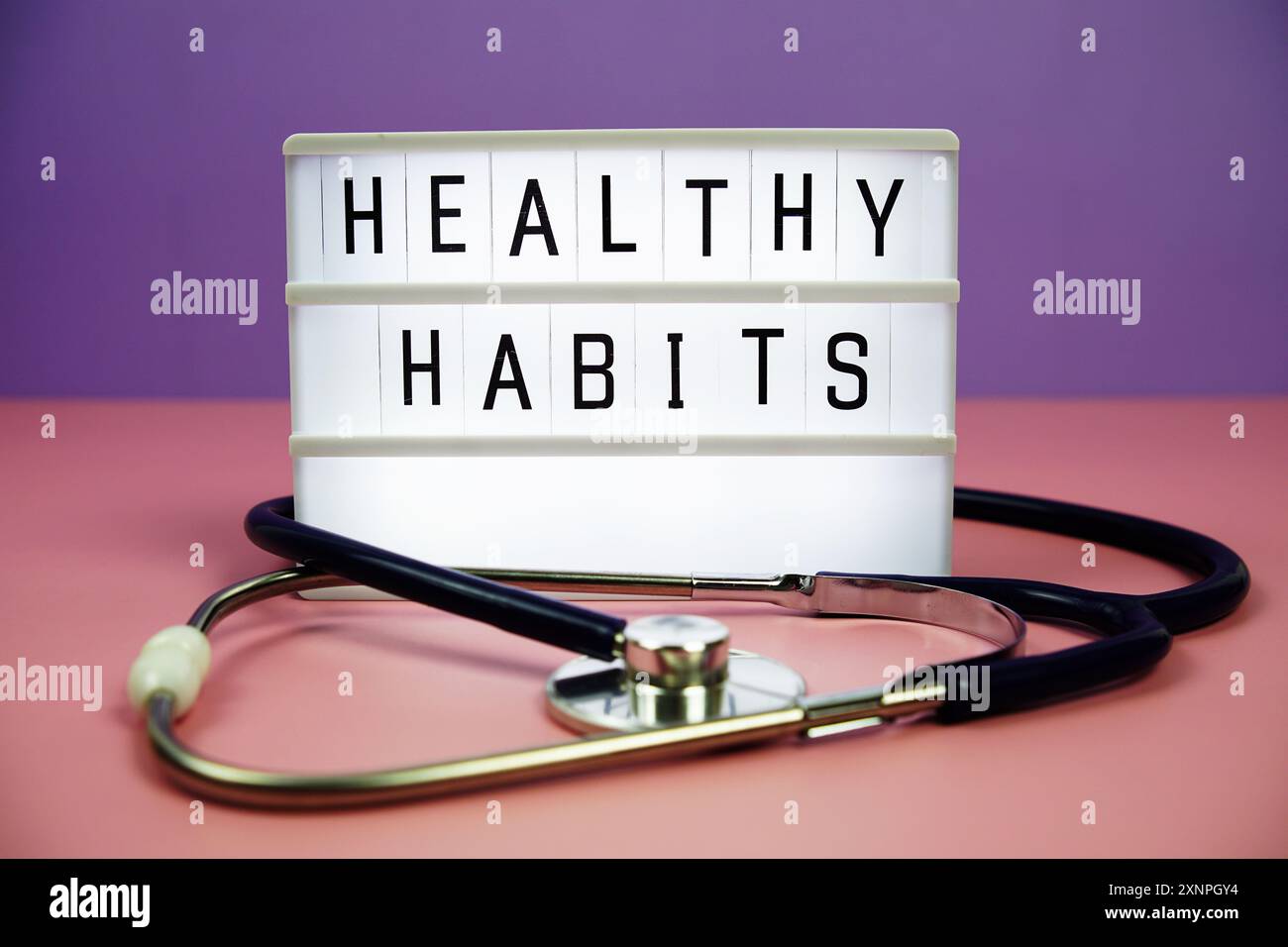 Healthy Habits letterboard text on LED Lightbox and stethoscope on pink ...