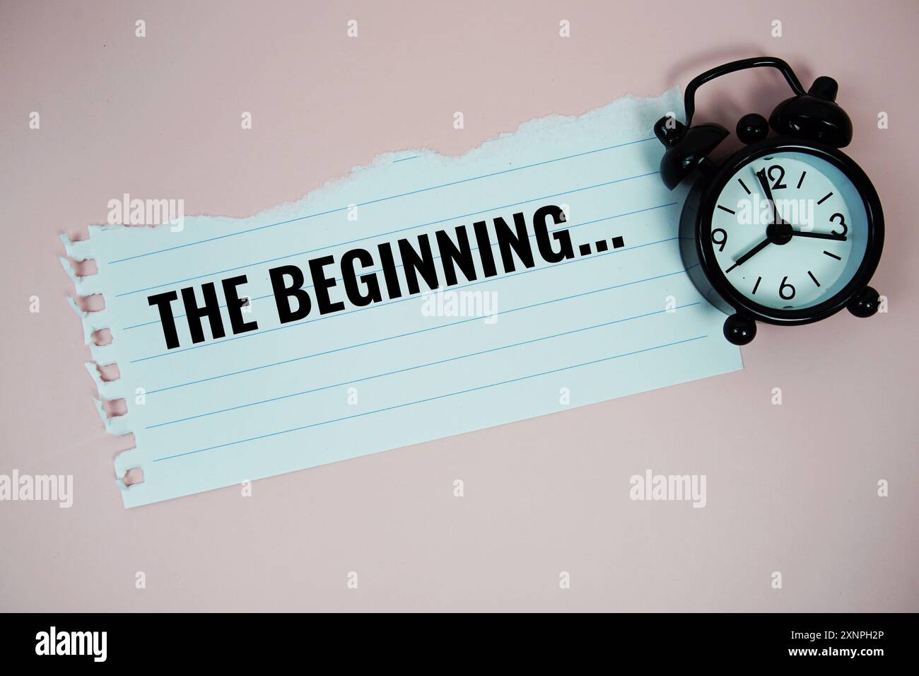 The Beginning quotes text on paper torn with alarm clock top view on ...