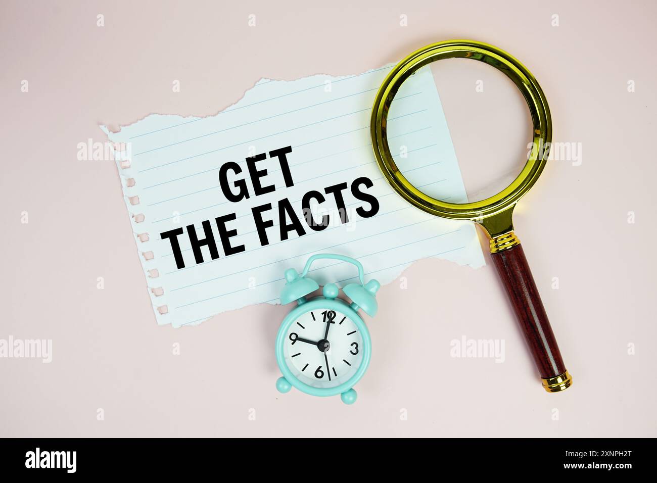 Get The Facts quotes text on paper torn with alarm clock and magnifying ...