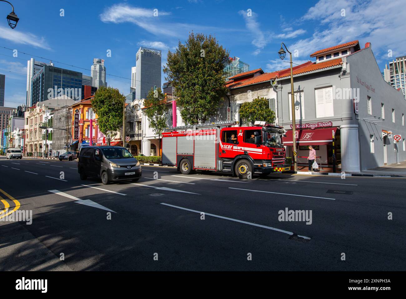 A fire engine vehicle or fire truck, emergency travel on road street at Chinatown. Dial 995 for ...