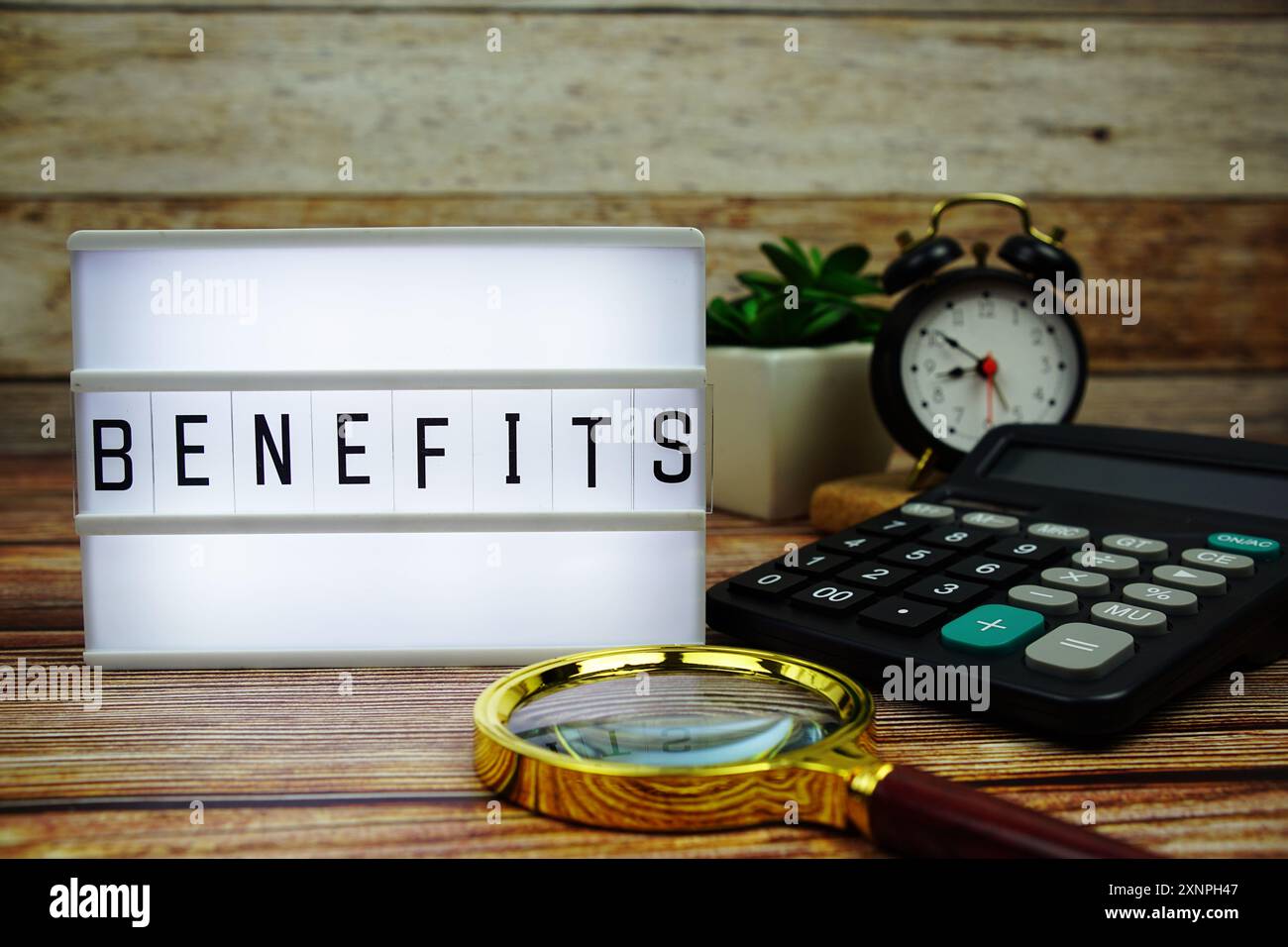 BENEFITS letterboard text on LED Lightbox on wooden background ...