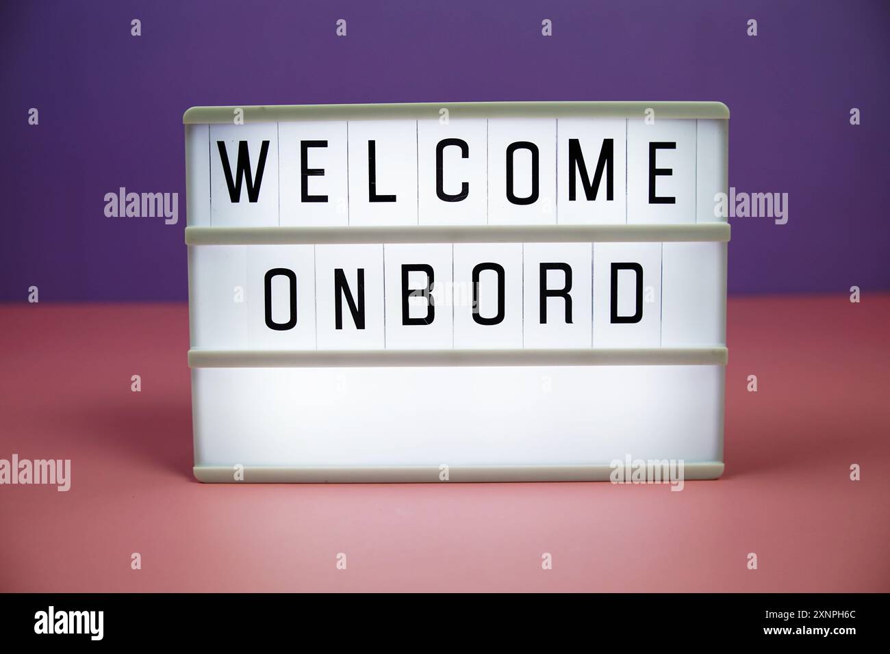 Welcome Onboard letterboard text on LED Lightbox on pink and purple ...