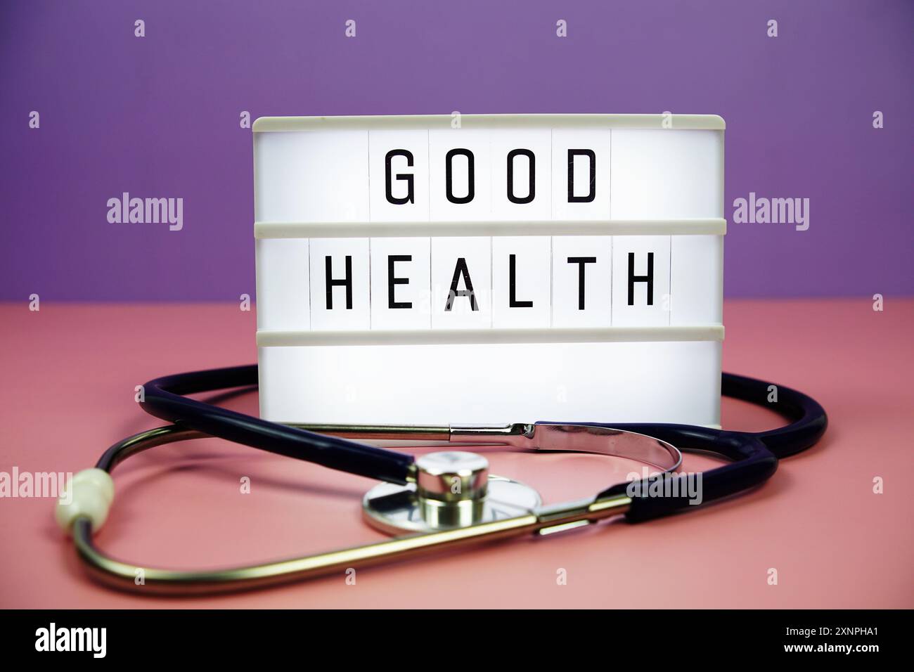 Good Health letterboard text on LED Lightbox and stethoscope on pink ...