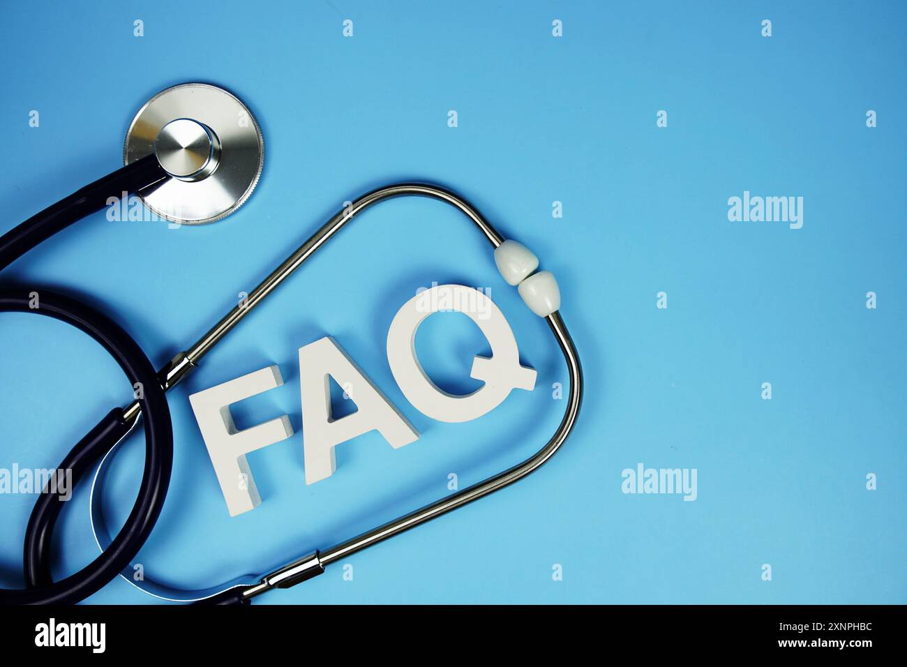 FAQ with wooden blocks alphabet letters and stethoscope on blue ...