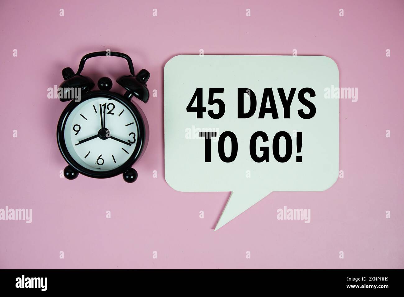 45 Days to go text on speech bluble with alarm clock top view on pink ...