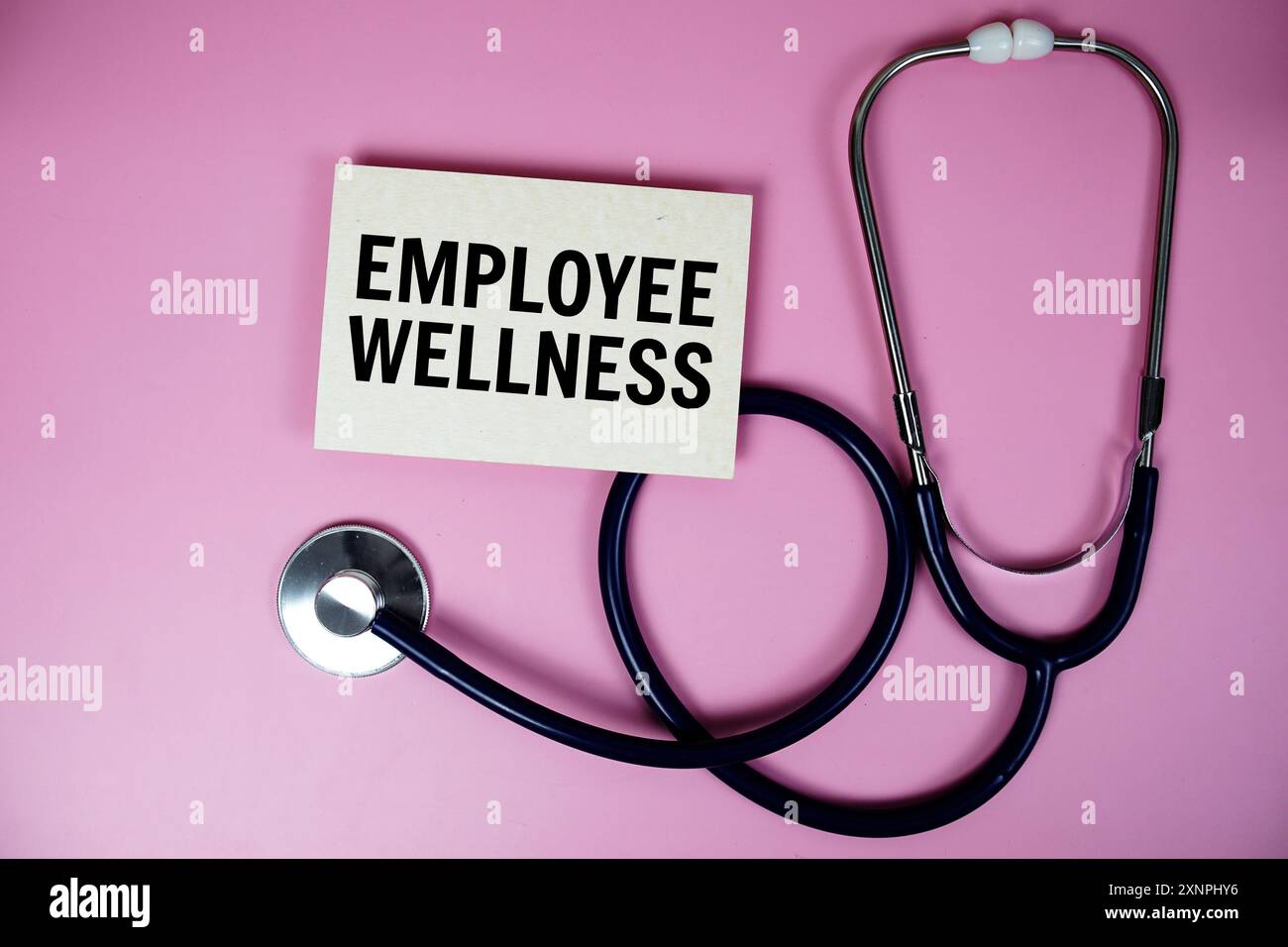 Employee Wellness program text with stethoscope on pink background ...