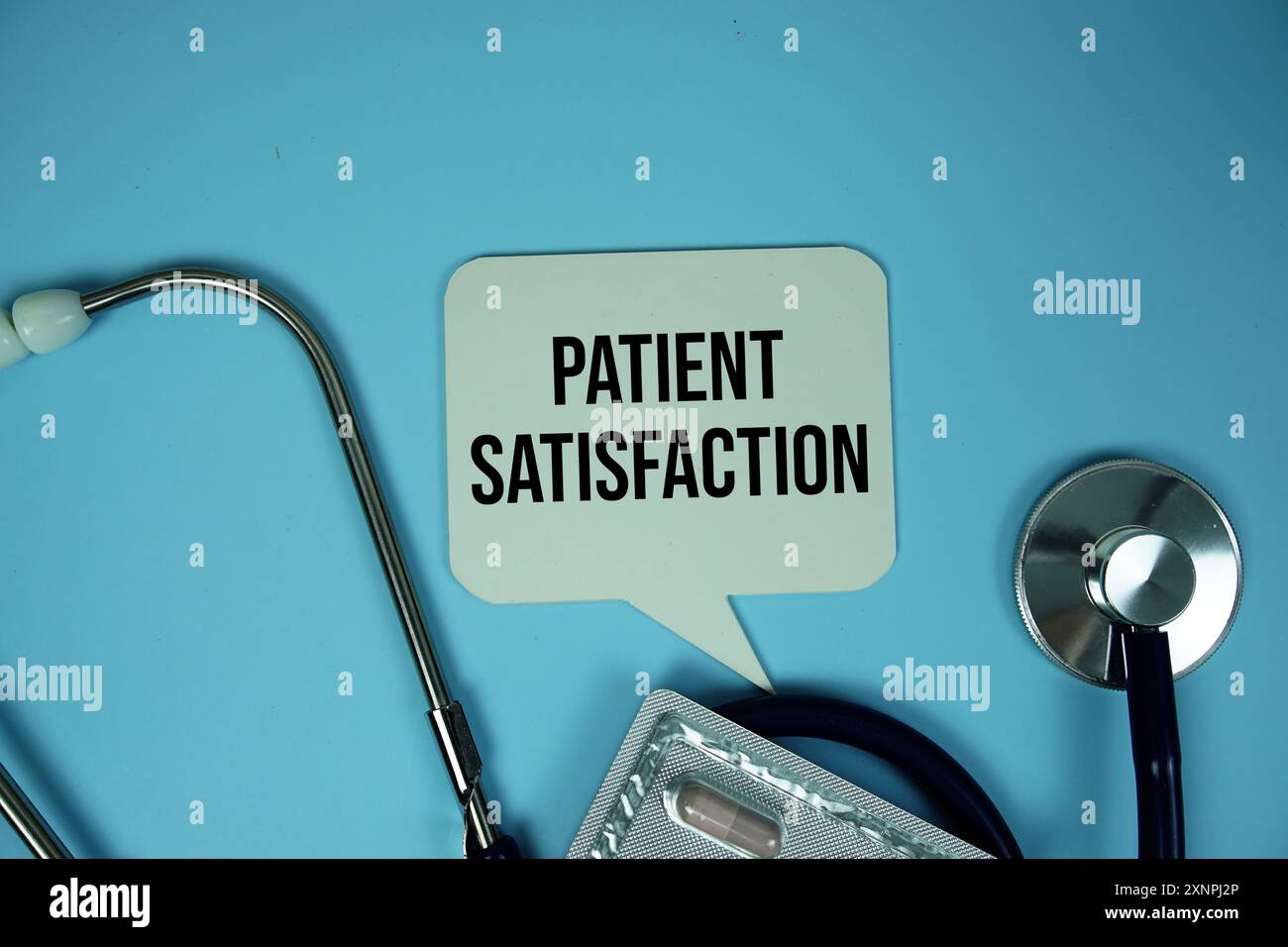 Patient Satisfaction text with stethoscope and capsule medicine on blue ...