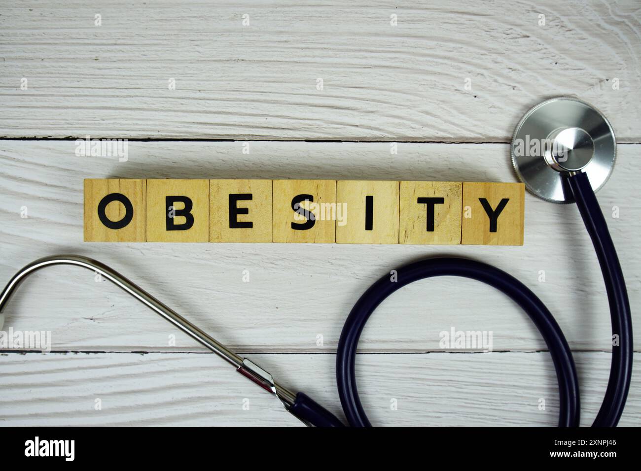 Obesity with wooden blocks alphabet letters and stethoscope on wooden ...