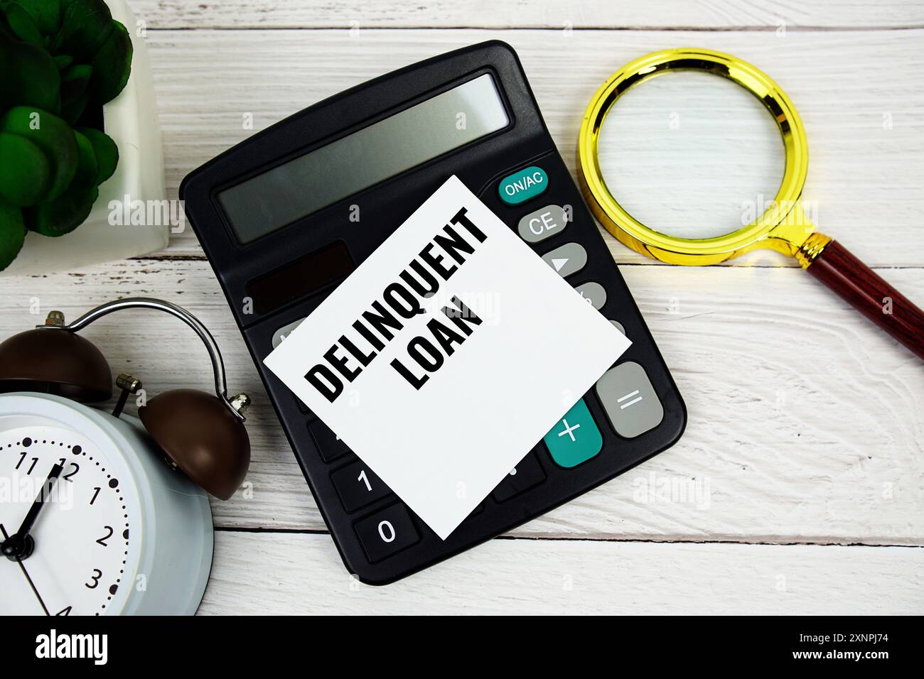Delinquent Loan text message with calculate, alarm clock and magnifying ...