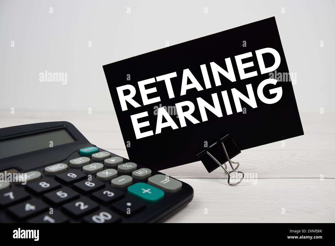 Retained Earning text message with calculate on wooden background Stock ...