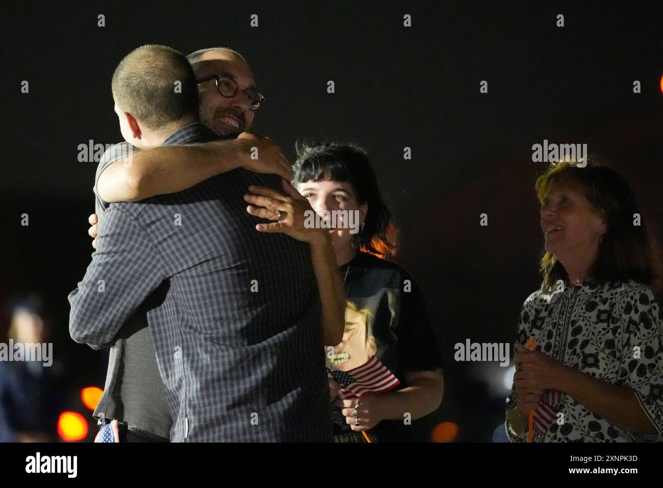 Reporter Evan Gershkovich, from left, hugs brother-in-law Anthony ...