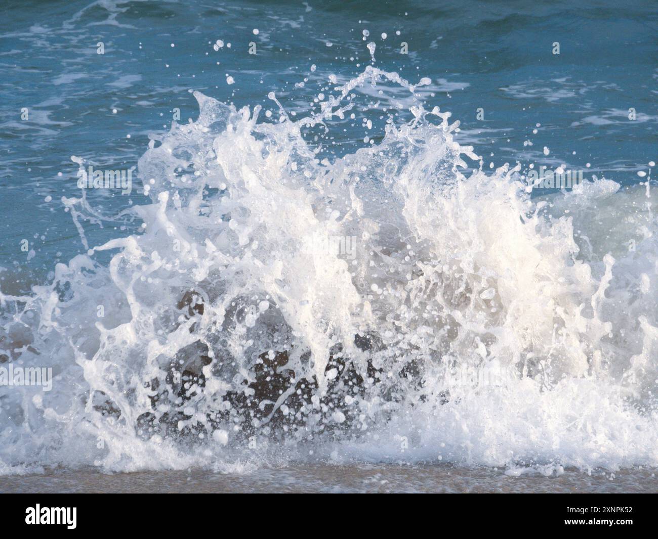 The sea waves hit the beach in white foam Stock Photo - Alamy