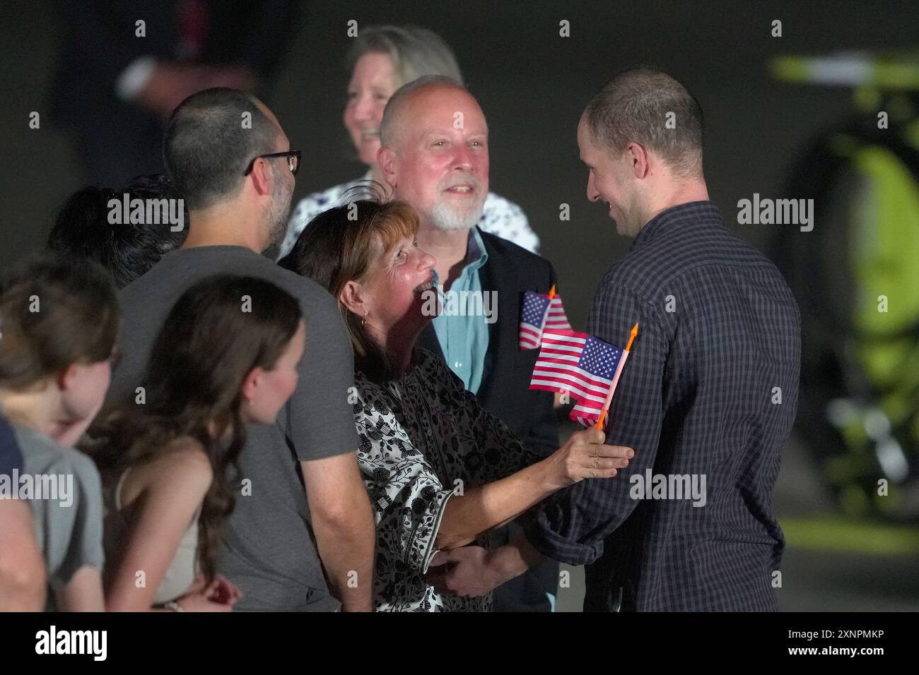 Reporter Evan Gershkovich, right, is greeted by his parents, Mikhail ...