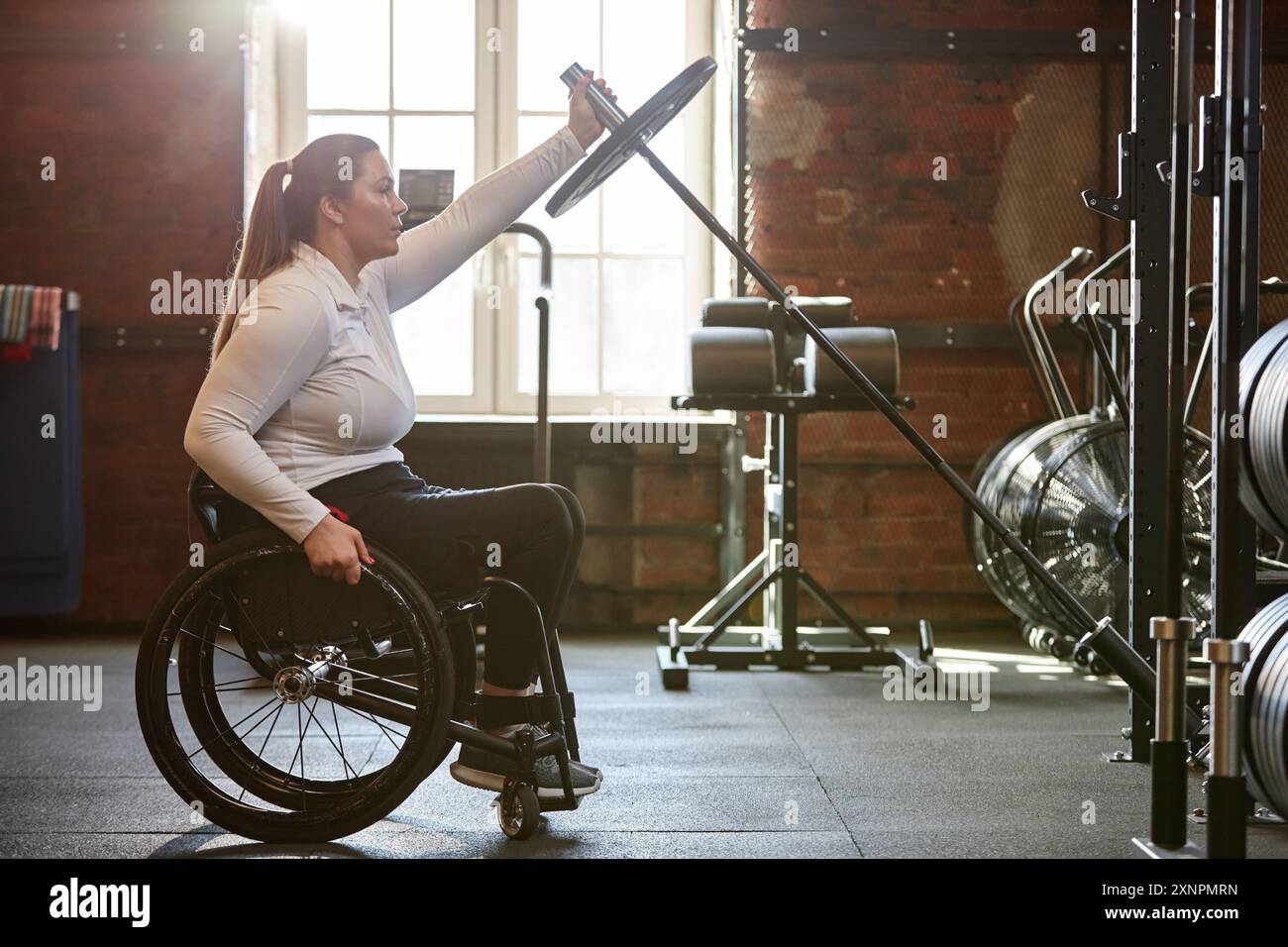 Side view portrait of adult woman with disability using wheelchair in ...