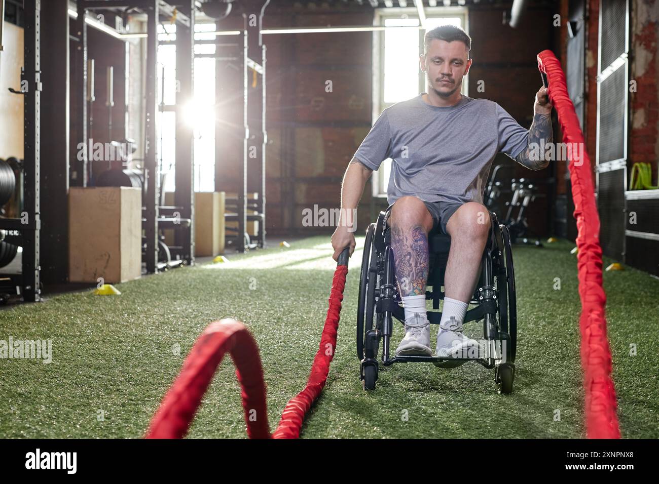 Front view full length portrait of young man with disability using ...