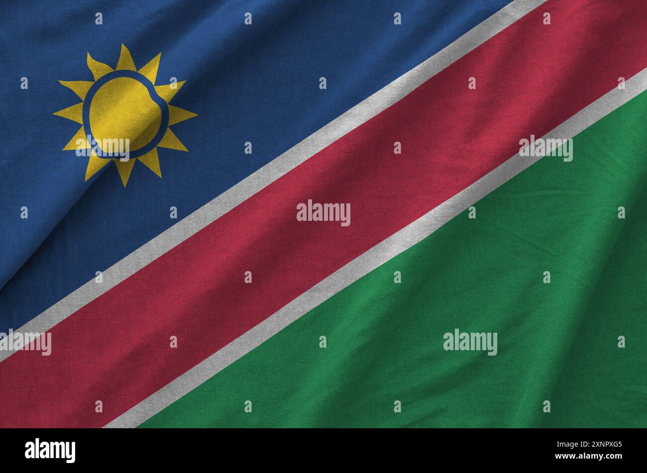 Namibia flag depicted on folded wavy fabric of old cloth close up Stock ...