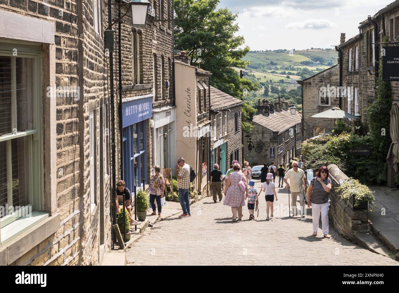People walking along Howarth Main Street, Yorkshire, England, UK Stock ...