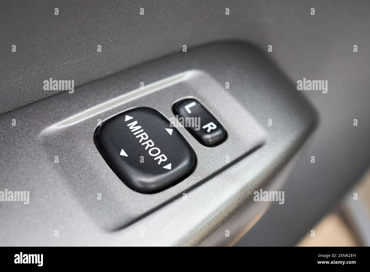 Modern hybrid electric car closeup interior detail. Driver door control ...