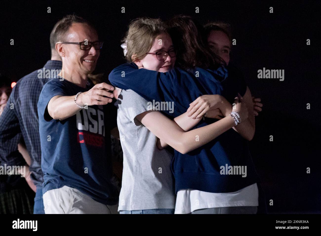 Alsu Kurmasheva, second right, hugs her husband Pavel Butorin, from ...