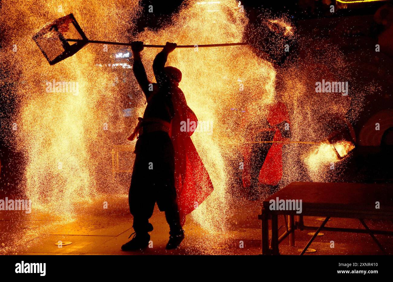 Handan, China. 02nd Aug, 2024. Artists are performing a fire-pot ...