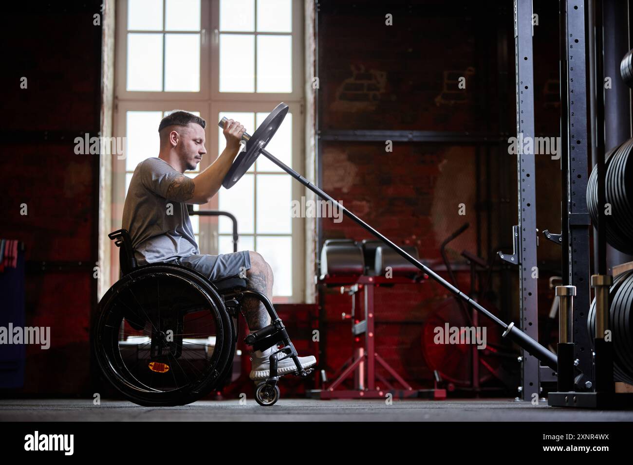 Motivational side view portrait of young man with disability using ...