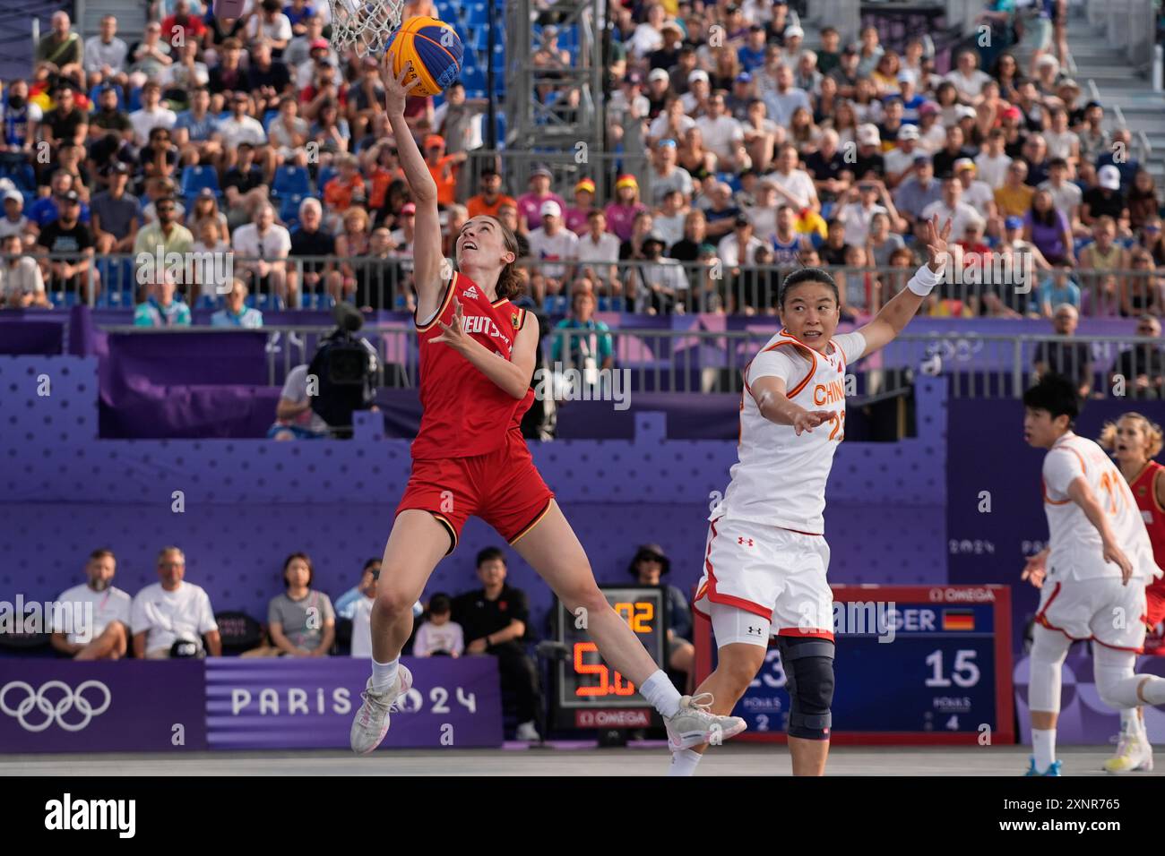 Germany's Elisa Mevius (8) drives past China's Wang Lili (23) in the ...