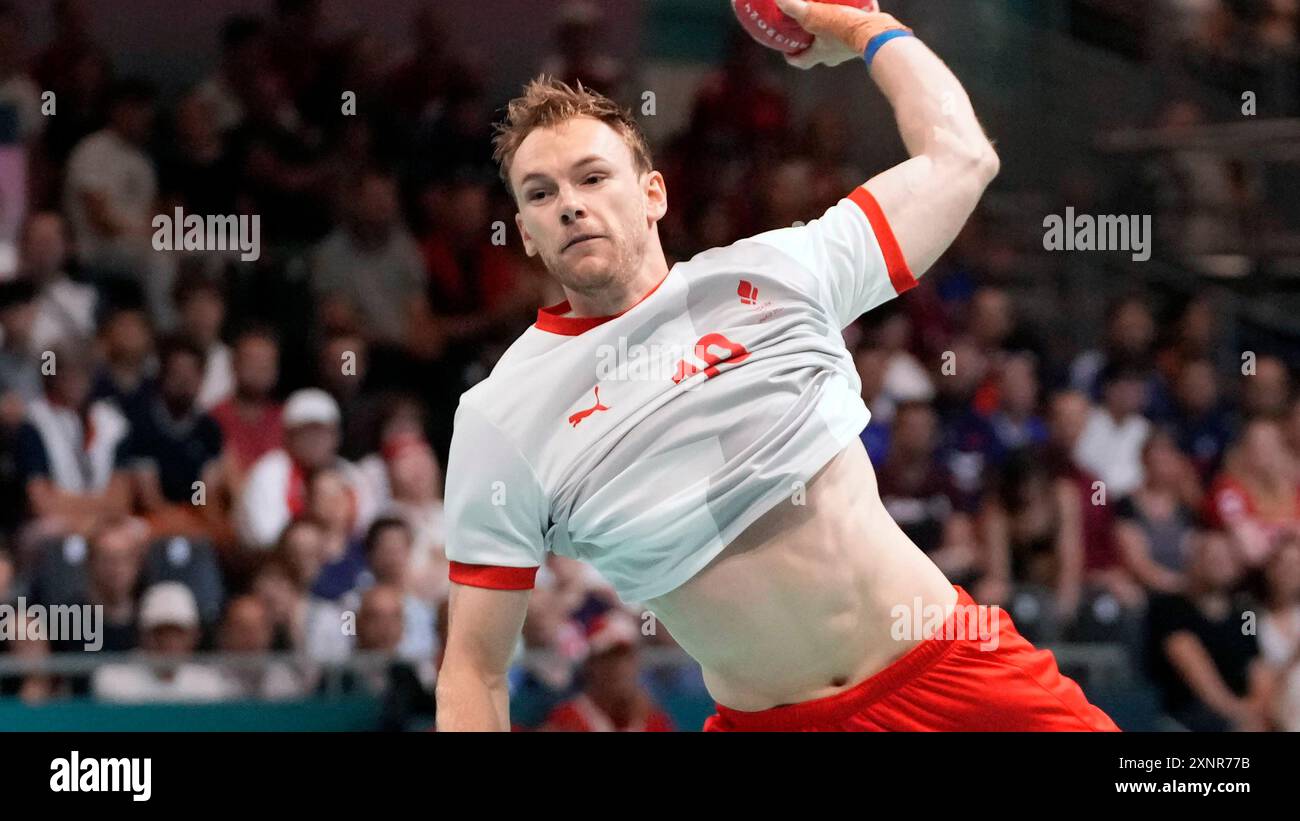 Mathias Gidsel, of Denmark, attempts to score, during a men's handball match between Denmark and ...
