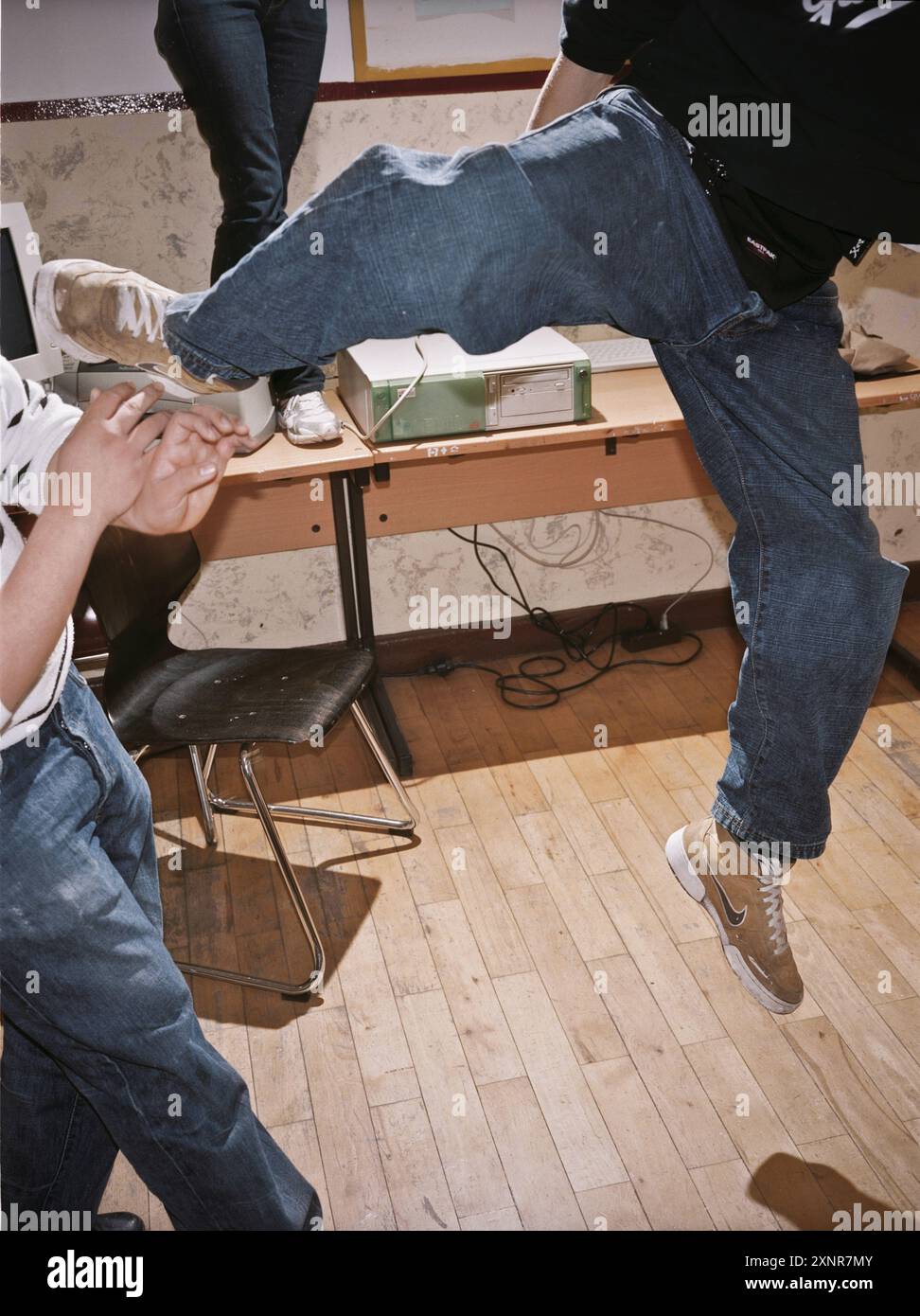 Dramatic re-enactment of a violent school fight in a classroom setting ...