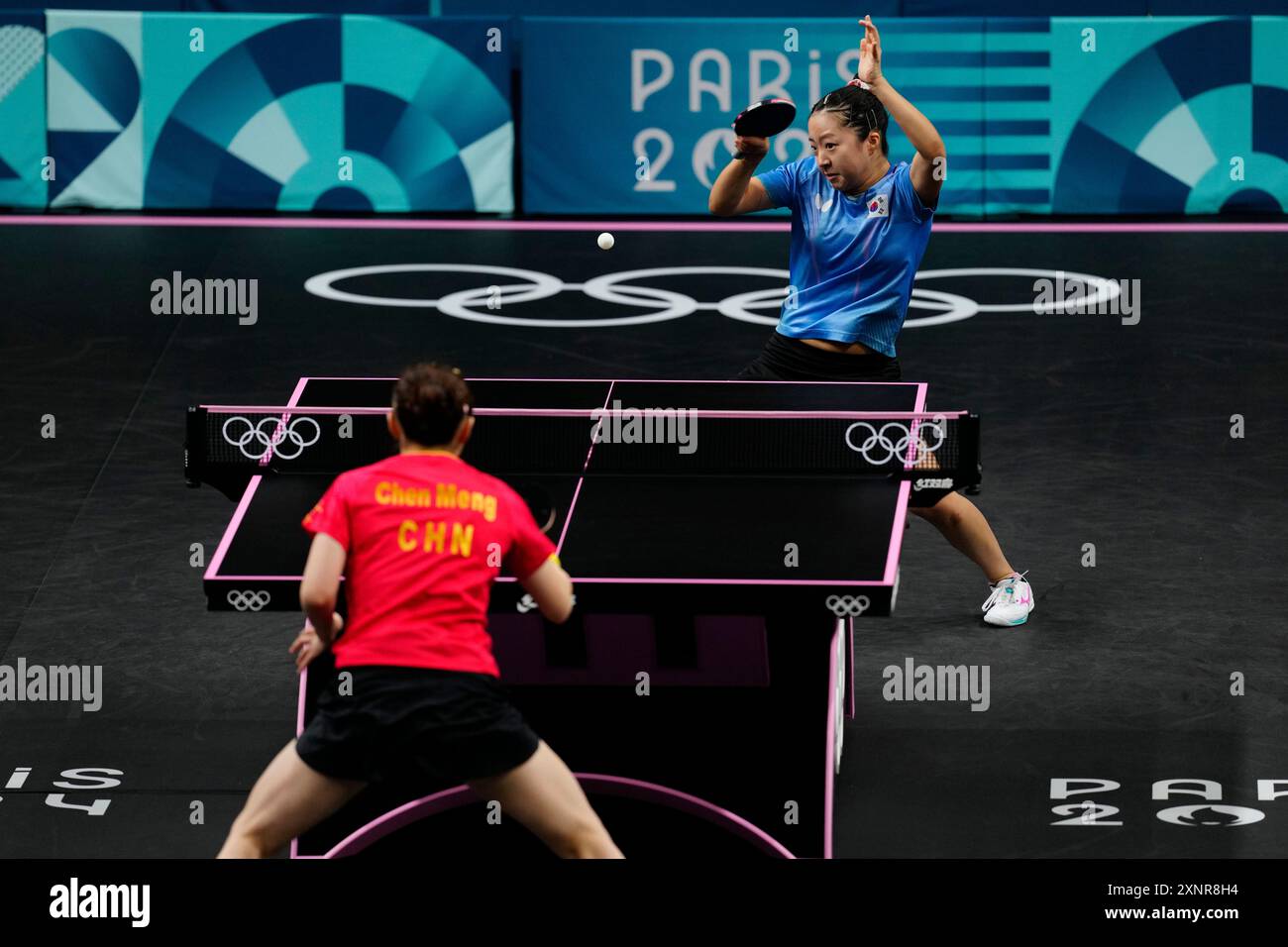 South Korea's Shin Yubin, background, plays against China's Chen Meng ...
