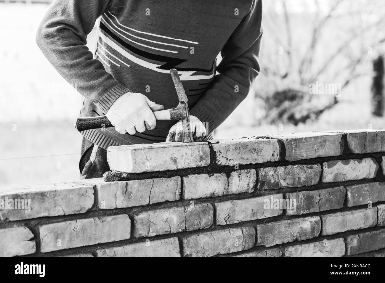 Construction mason builds brick Black and White Stock Photos & Images ...