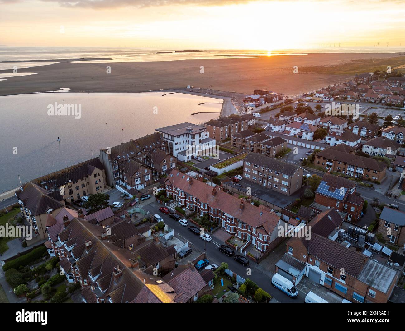 Aerial view of West Kirby village and marine lake at sunset, Wirral ...