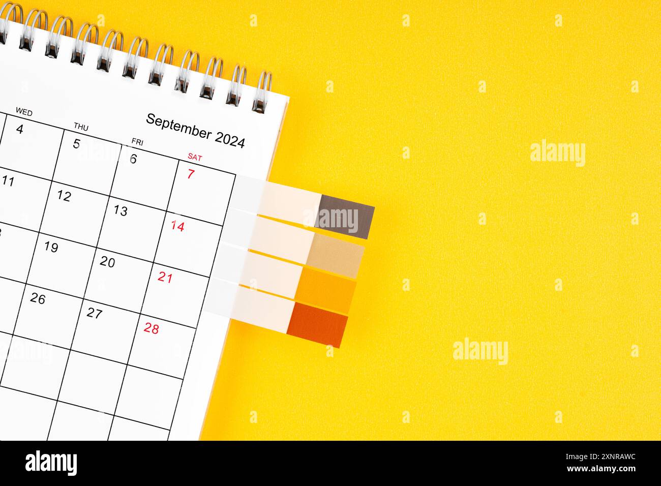 September 2024 Monthly desk calendar and blank adhesive note on yellow ...