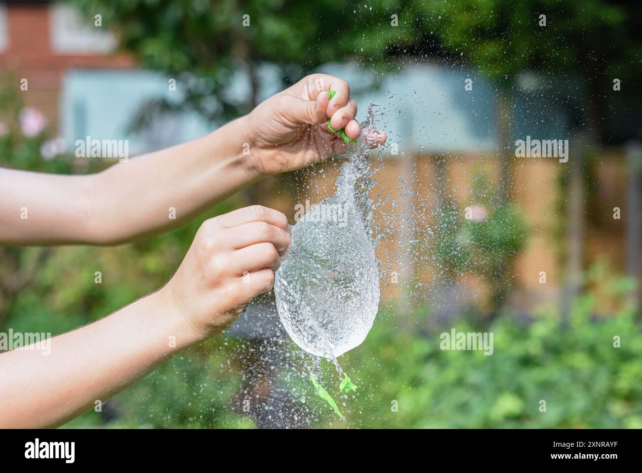 Water balloon being burst hi-res stock photography and images - Alamy