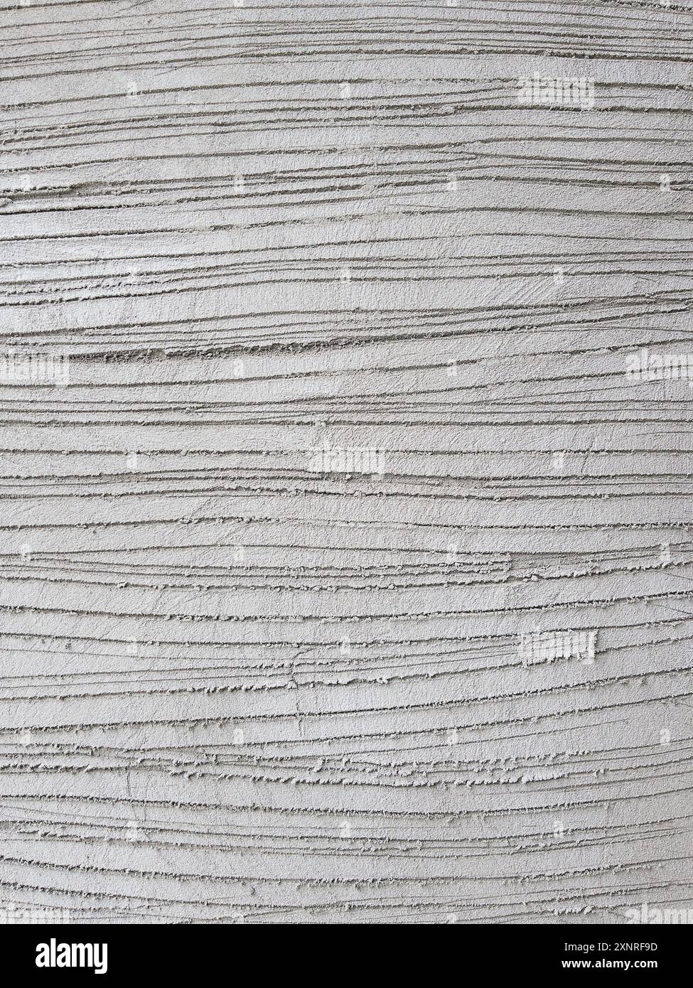 Close-up of a concrete surface featuring linear texture patterns ...