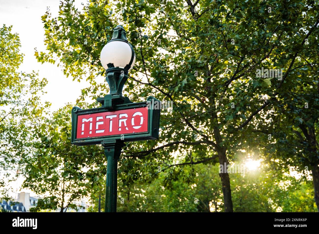 Vintage "Metro" (subway) red sign with globe street lamp post in Paris ...