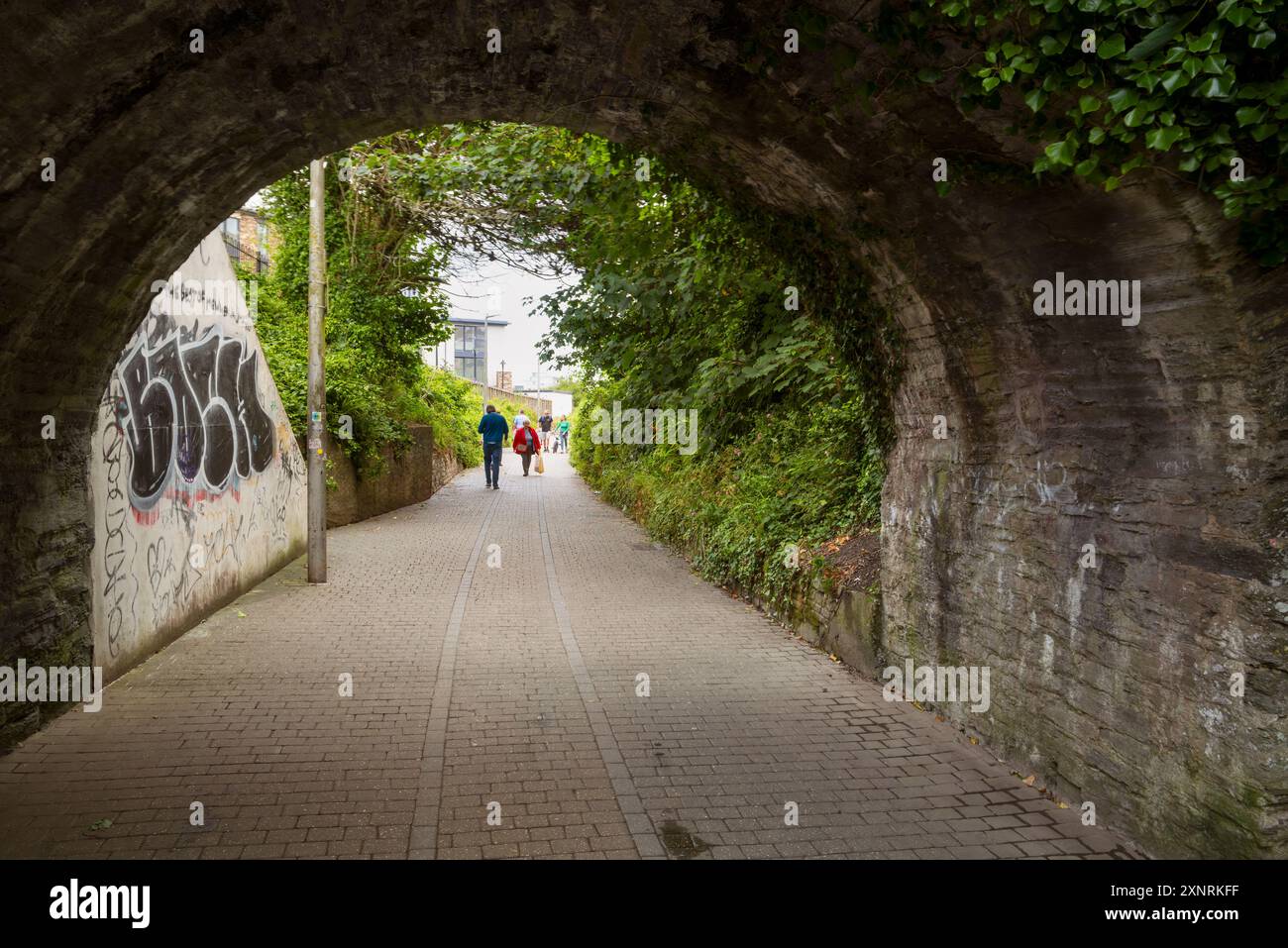 People walking along the route of the historic tram track in Newquay ...