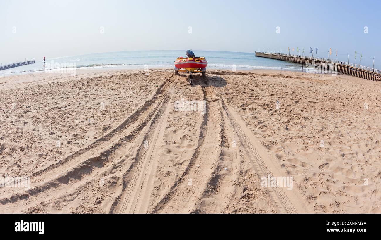 Beach ocean with lifeguard rescue boat on trailer along coastline Stock ...