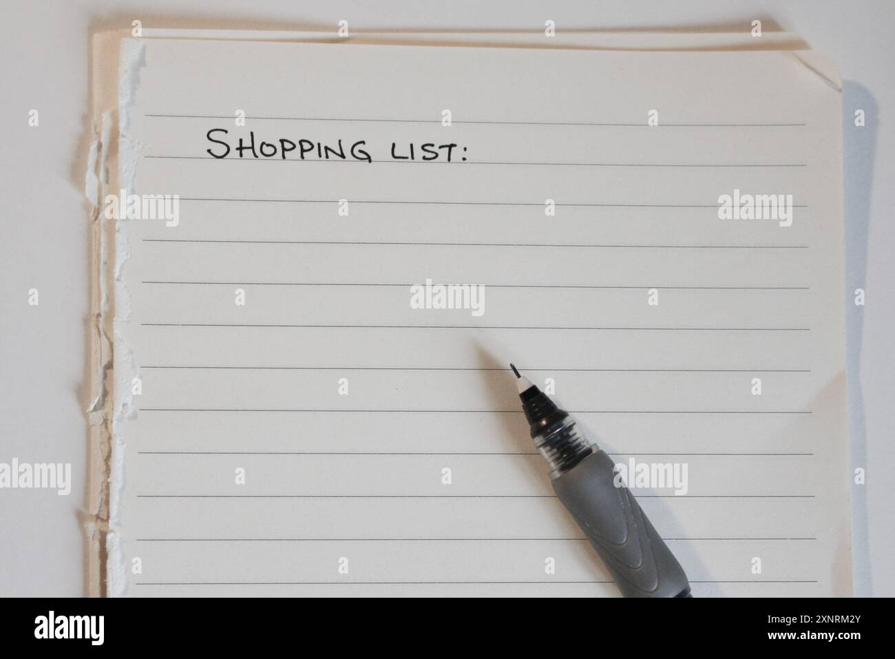 A photograph of notebook pages, with 'shopping list' written, and a ...