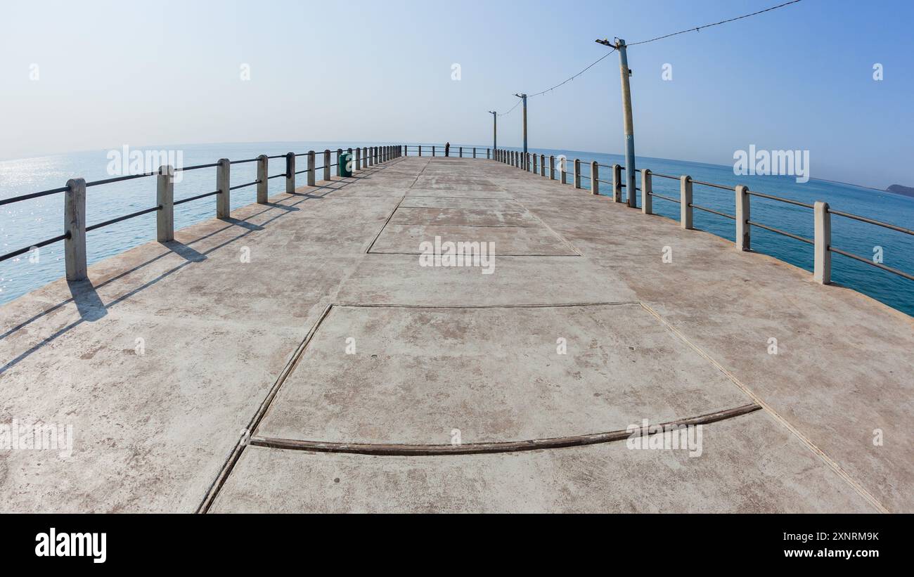 Beach standing middle of public pier jetty towards clear blue ocean ...