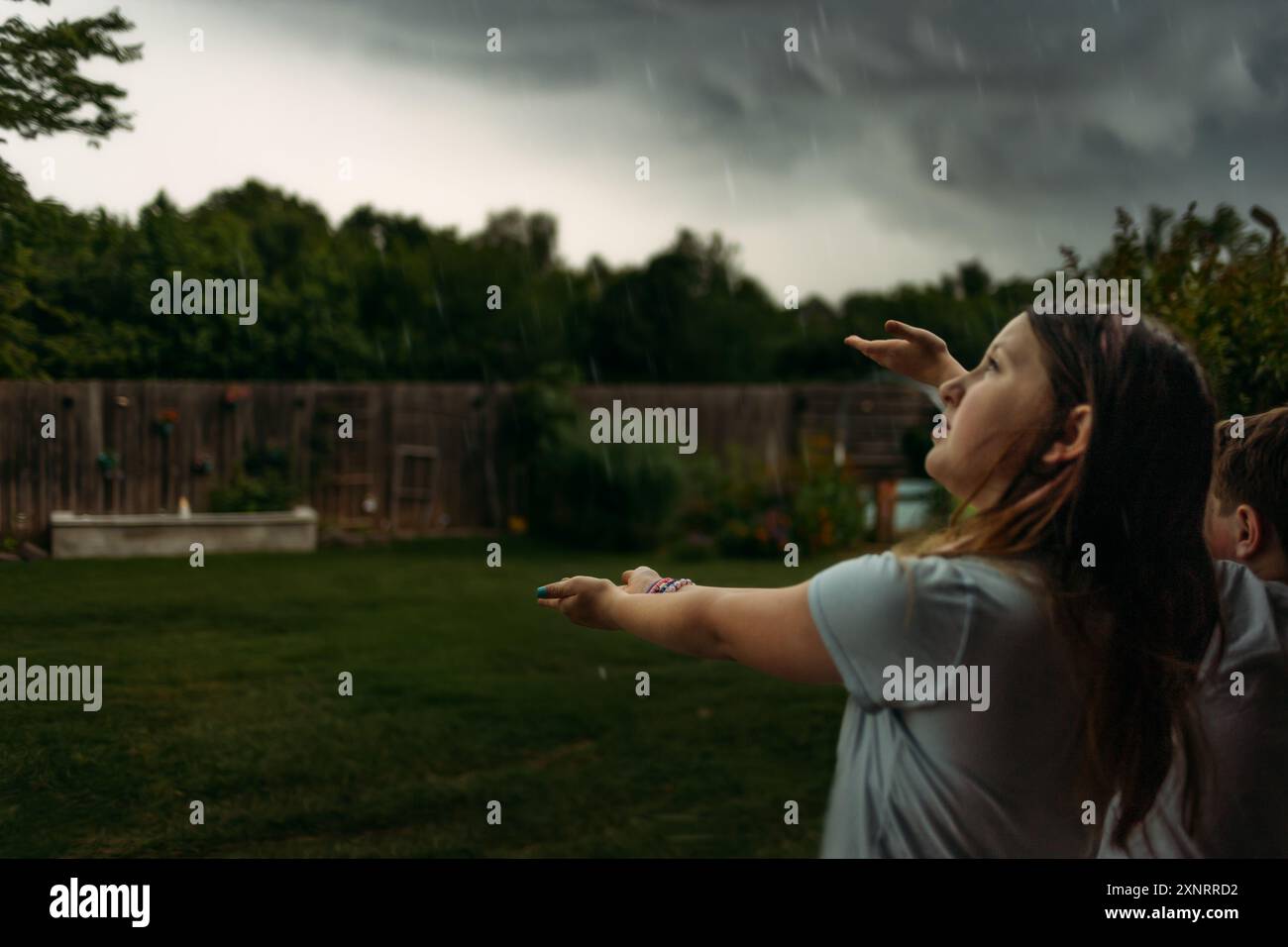 Children checking for summer rain Stock Photo - Alamy