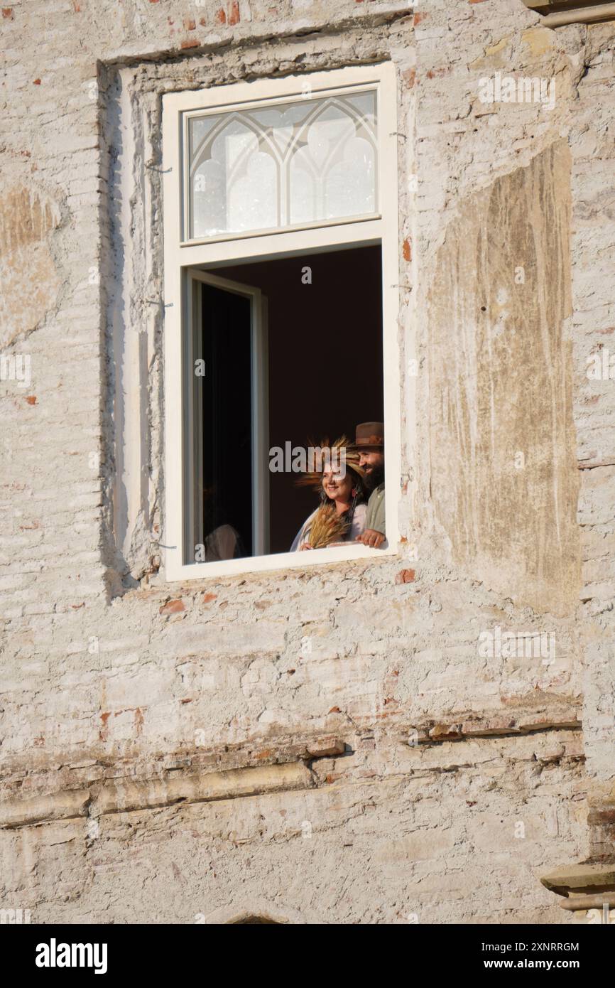 couple posing in the window of a castle Stock Photo - Alamy