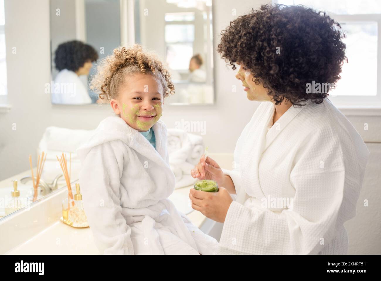 Little sister is smiling at the camera with a face mask Stock Photo - Alamy