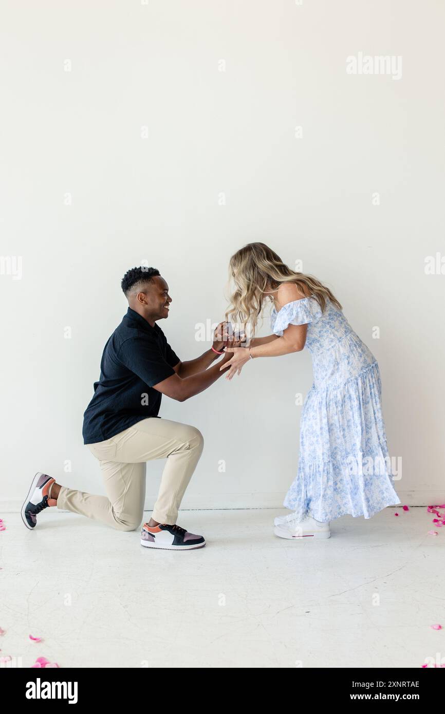 Man proposing to a surprised woman Stock Photo - Alamy
