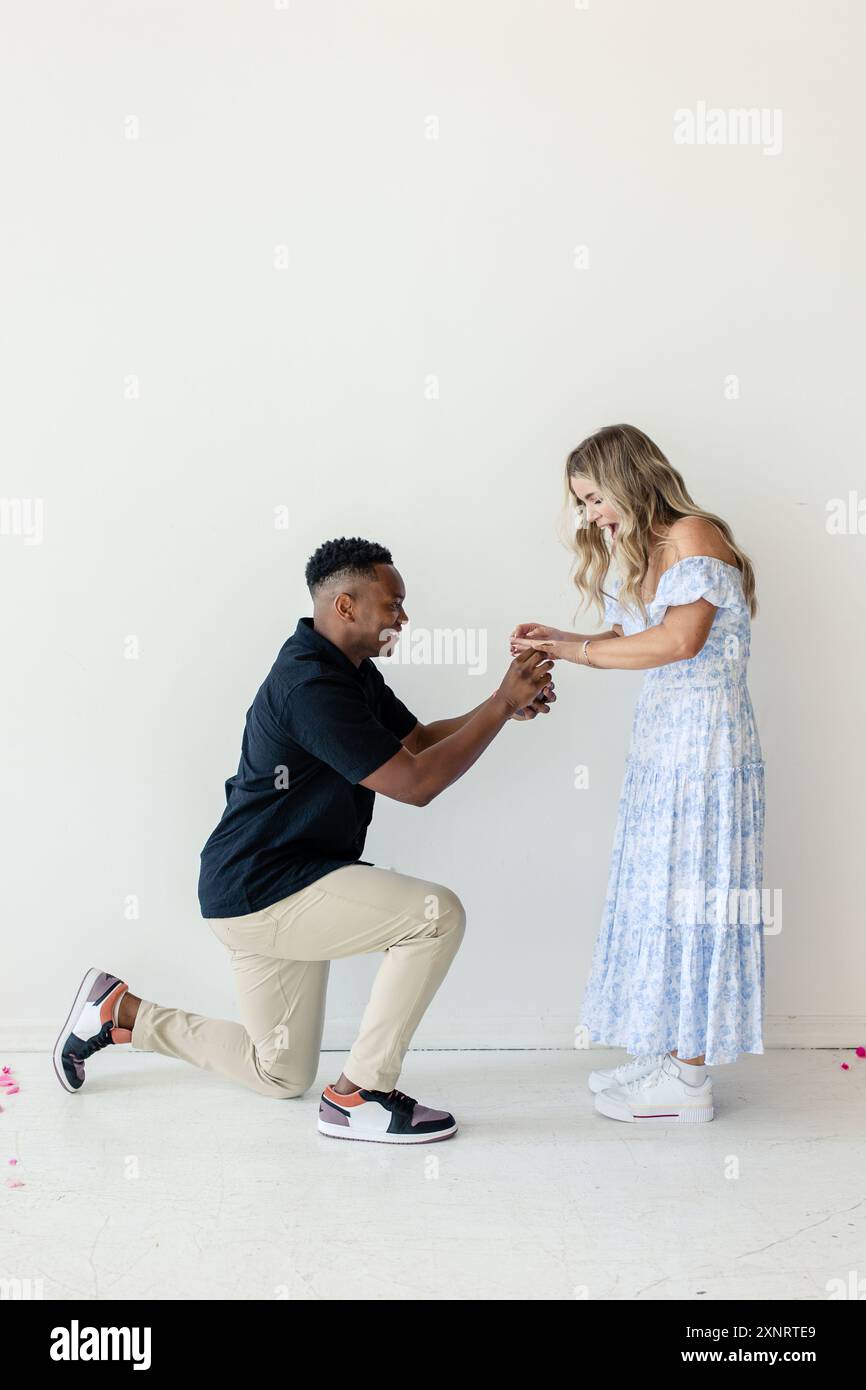 Man placing a ring on a woman's finger during a proposal Stock Photo ...